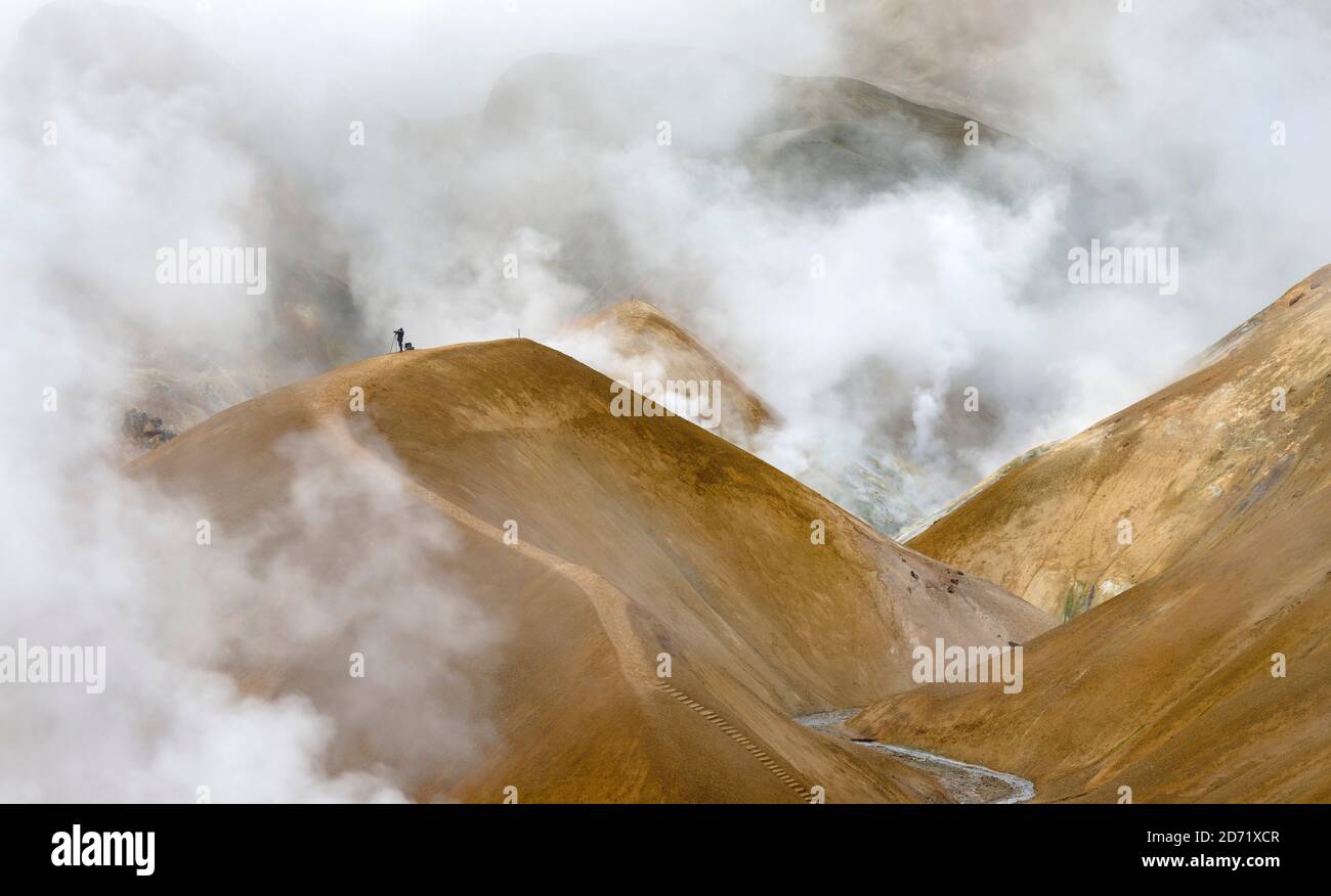 Visitors and photographers. Geothermal area Hveradalir in the mountains ...