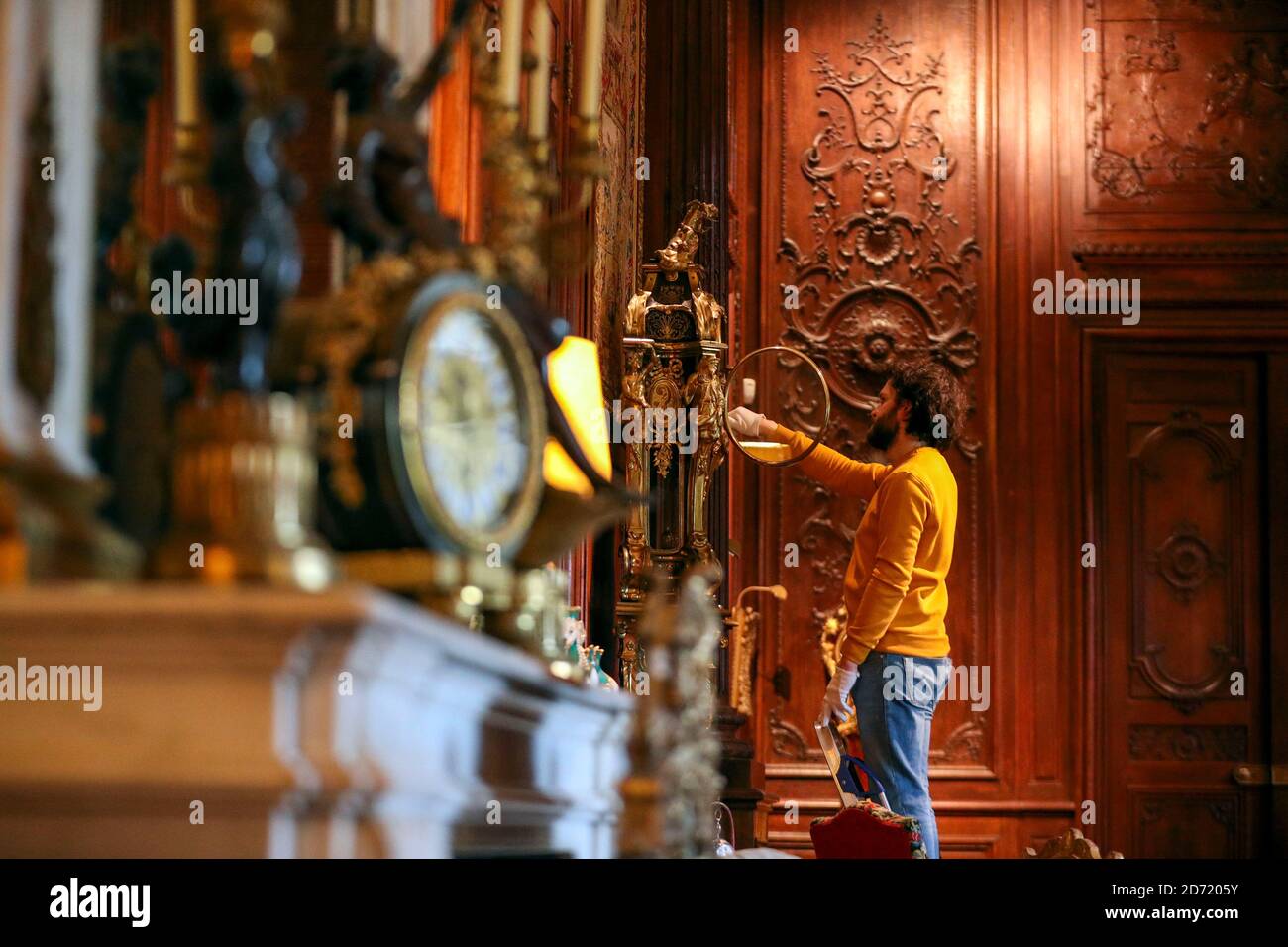 Assistant Head Steward Matthew Waters checks a clock at Waddesdon Manor ...
