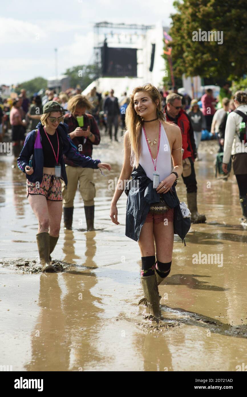 Festival goers brave the mud at the Glastonbury Festival, at Worthy ...