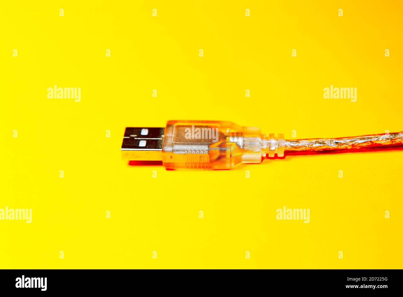 Transparent USB cable at yellow background Stock Photo - Alamy
