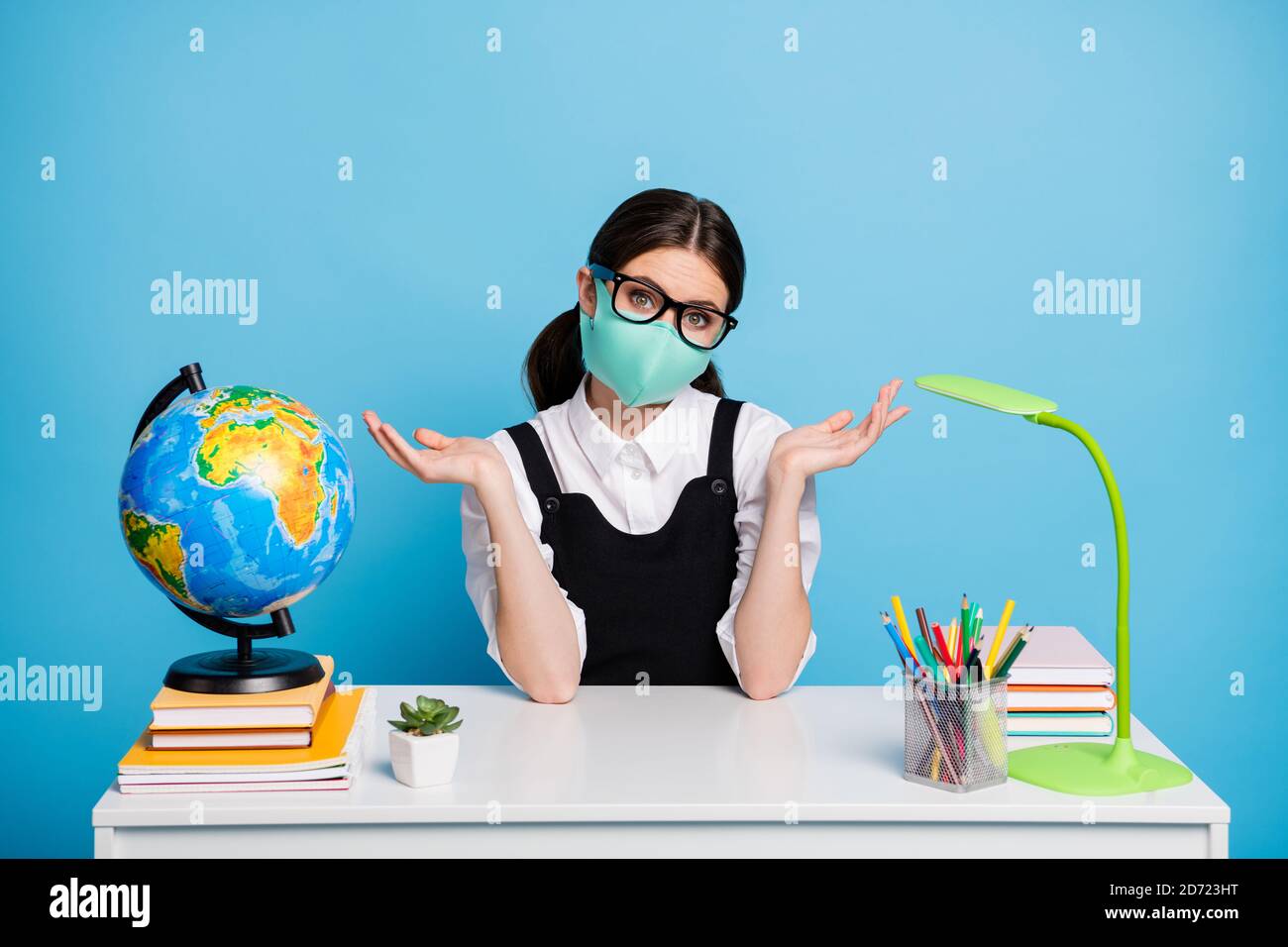 Photo of frustrated girl college student sit table shrug shoulders dont ...