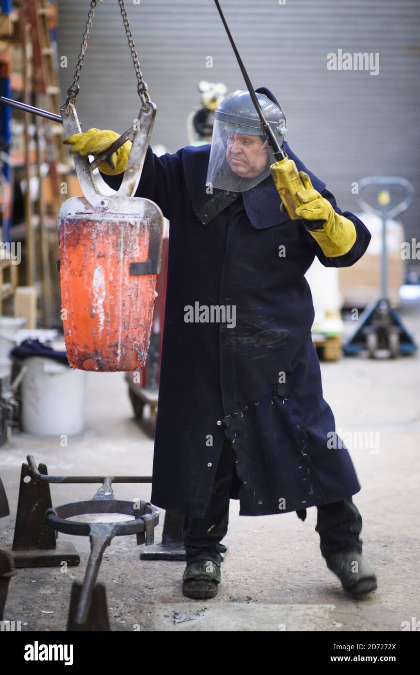 Furnace man Billy Smith prepares molten bronze during the making of ...