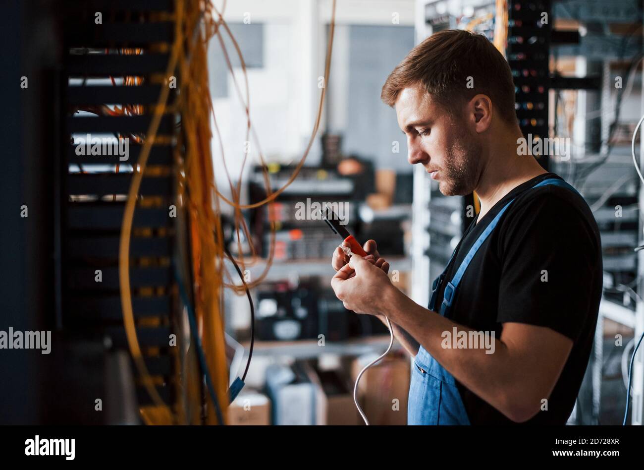 Young man in uniform with measuring device works with internet ...