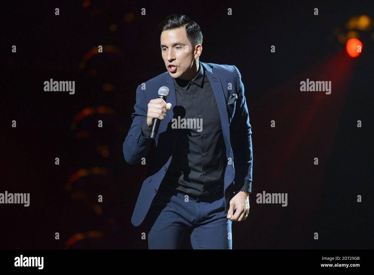Russell Kane performing on stage at the Royal Albert Hall in London for ...