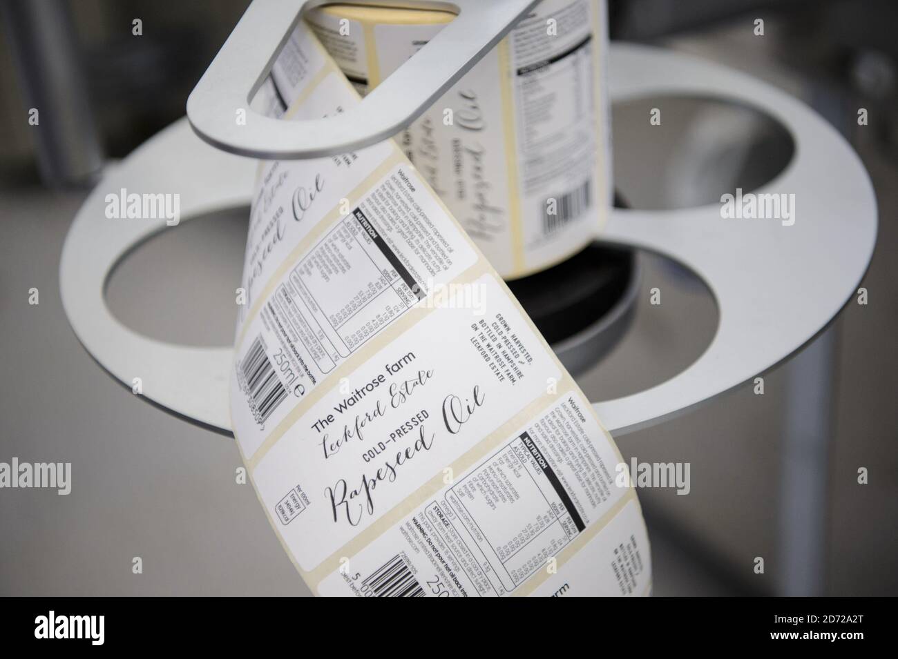 Rapeseed oil bottles are labeled by hand, on the Waitrose Leckford ...