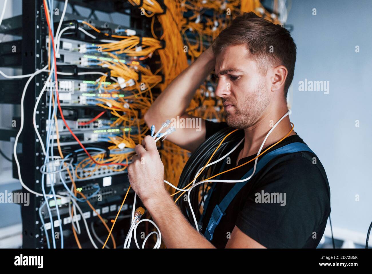 Young man in uniform feels confused and looking for a solution with ...