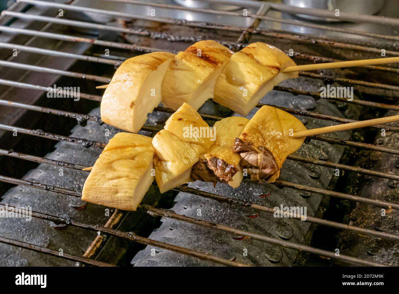 The close up of delicious grilled orinji mushroom at food street night ...