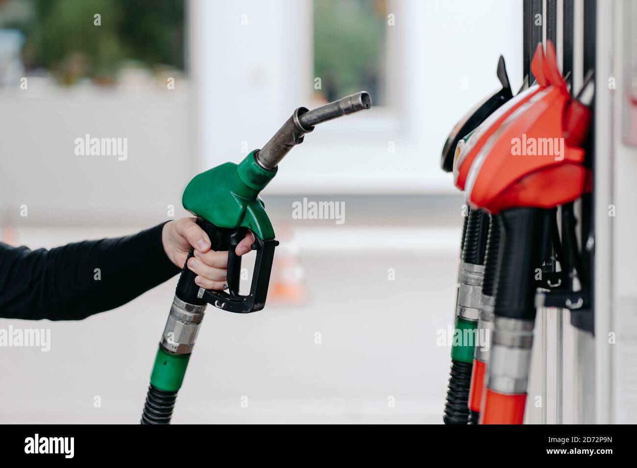 Car fueling concept. Mans hand using fuel nozzle at petrol station ...