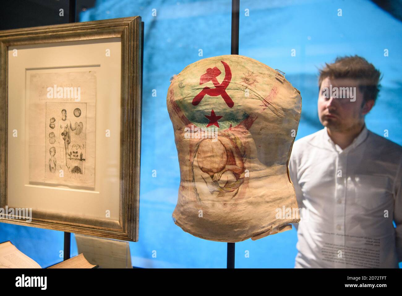 Visitors look at medical corsets owned by Frida Kahlo, part of the ...