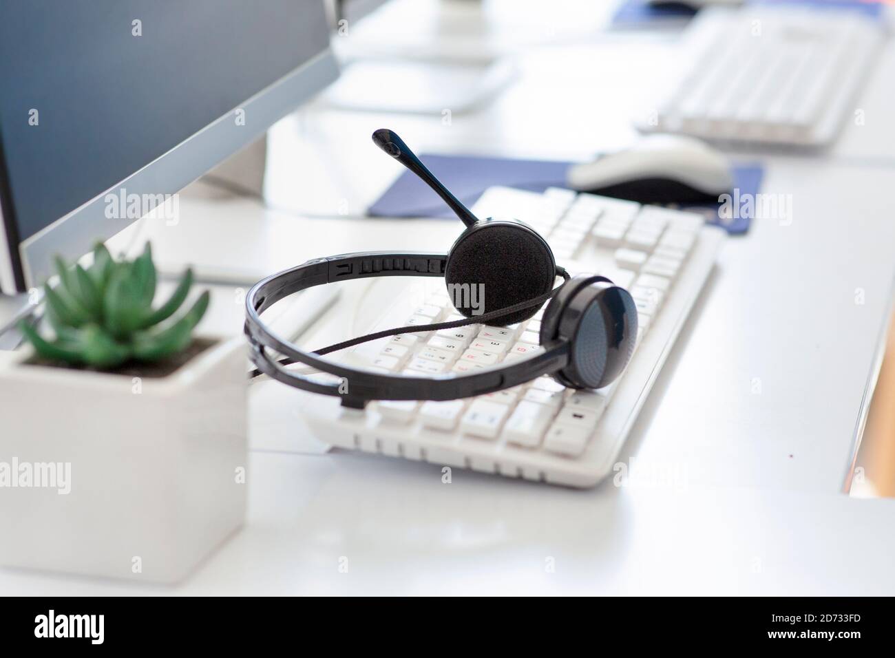 Hotline operator's desk with computer keyboard and modern headset at ...