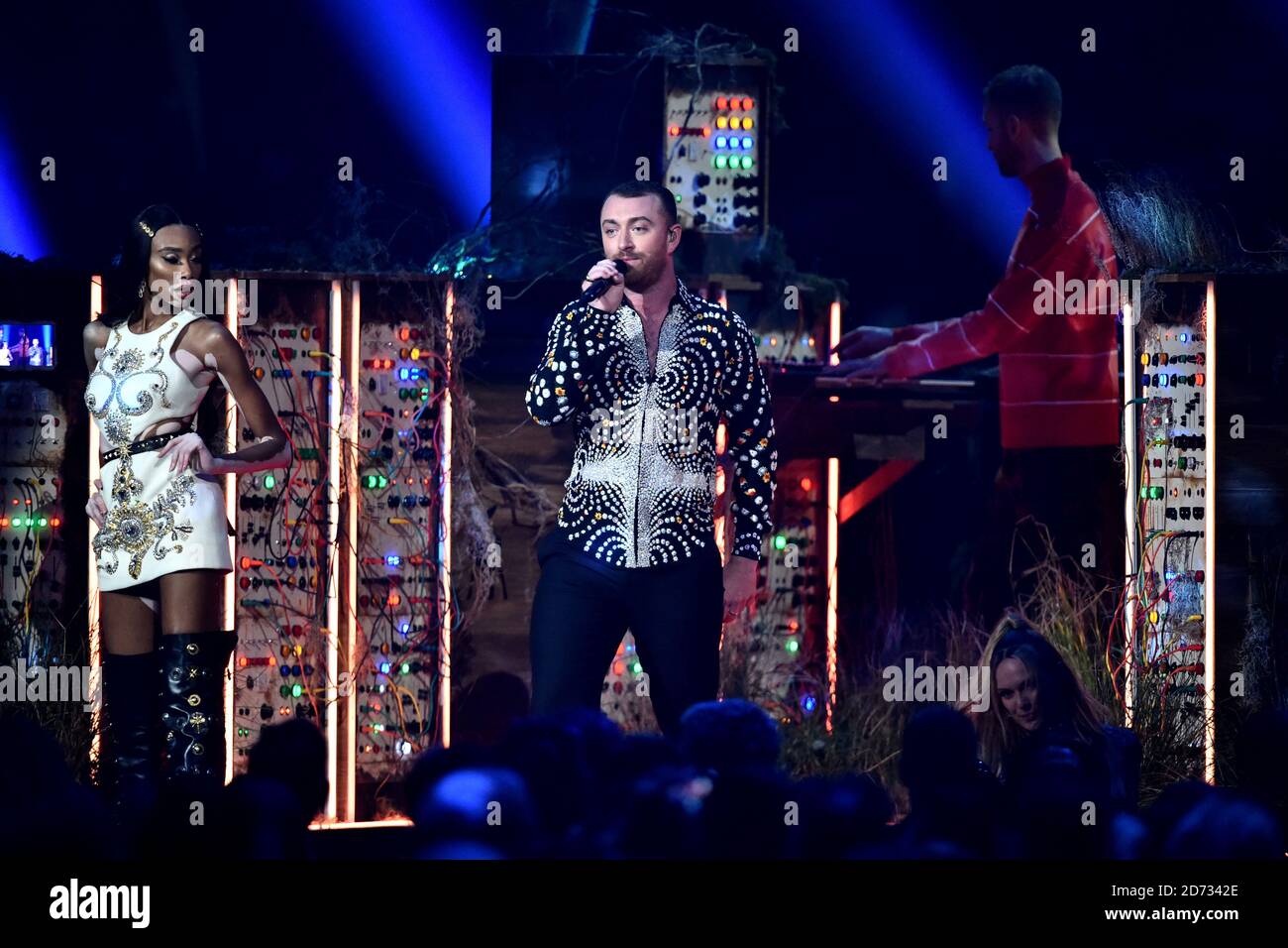 Winnie Harlow, Sam Smith and Calvin Harris on stage at the Brit Awards ...