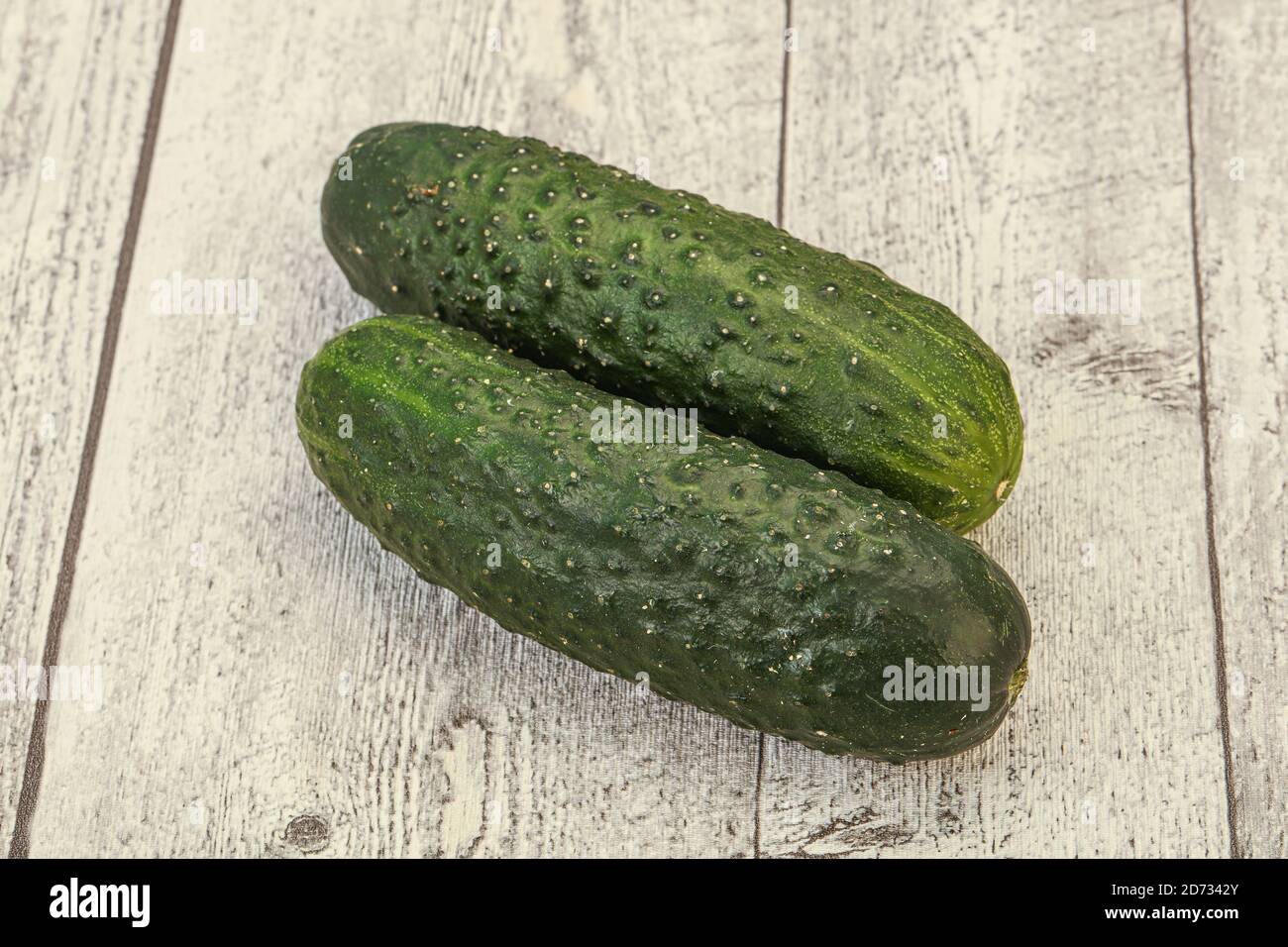 Green fresh two cucumbers over background Stock Photo - Alamy