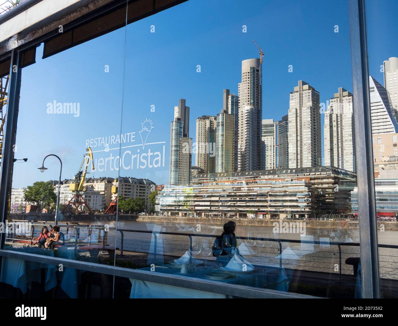 Modern skyscrapers are reflected in a window of a posh restaurant ...