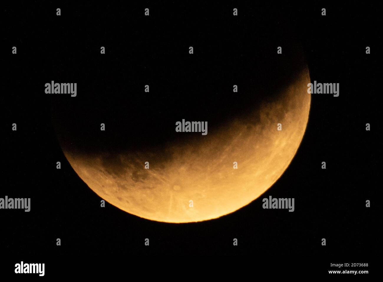The moon seen during a partial lunar eclipse, known as a half blood ...
