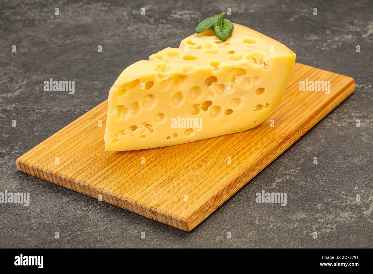 Maasdam cheese - dairy yellow triangle with holes Stock Photo - Alamy