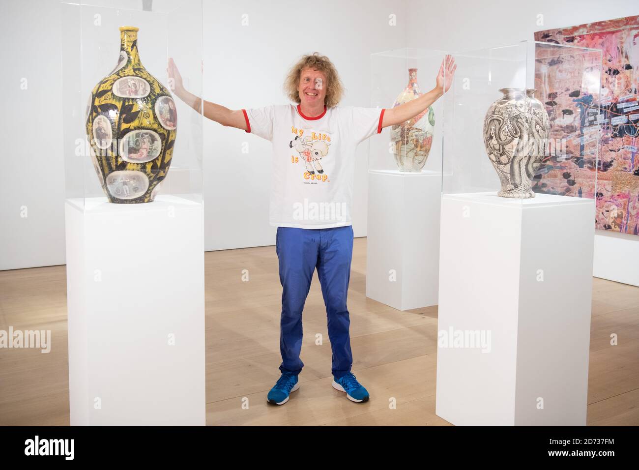 Artist Grayson Perry pictured with several of his ceramic works, at the ...