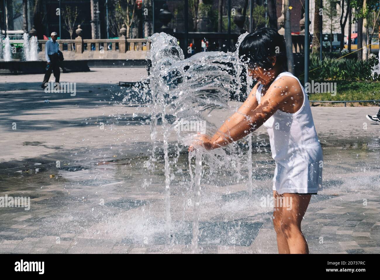 Kids playing in a fountain Stock Photo - Alamy