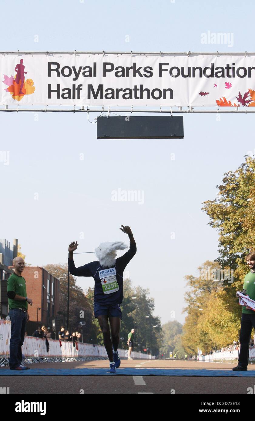 Winner John Muriithi crosses the finish line dressed as a rabbit at the ...