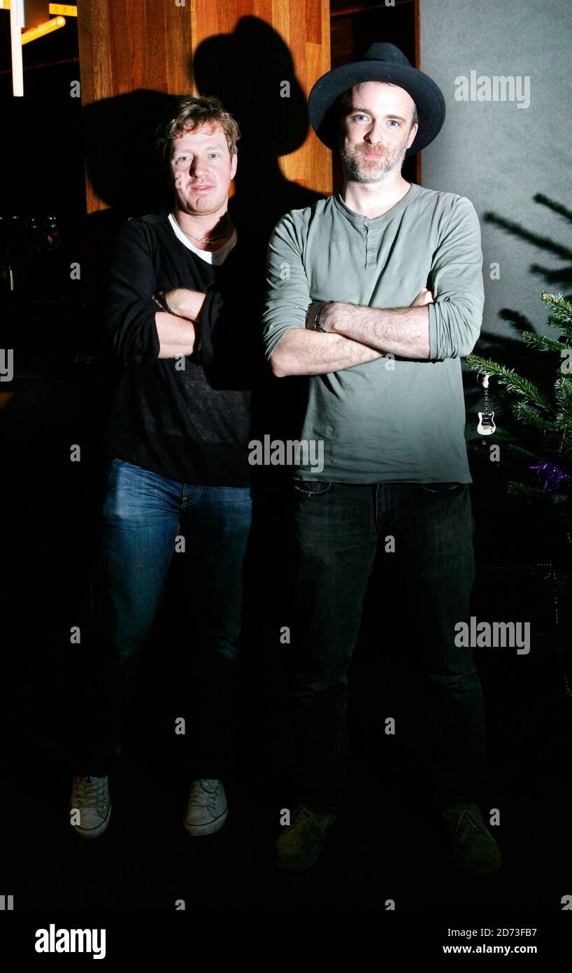 Andy Dunlop (left) and Fran Healey of Travis pose for photographs after ...