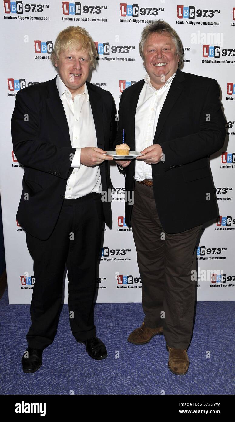 London mayor Boris Johnson (left) is presented with a first birthday ...