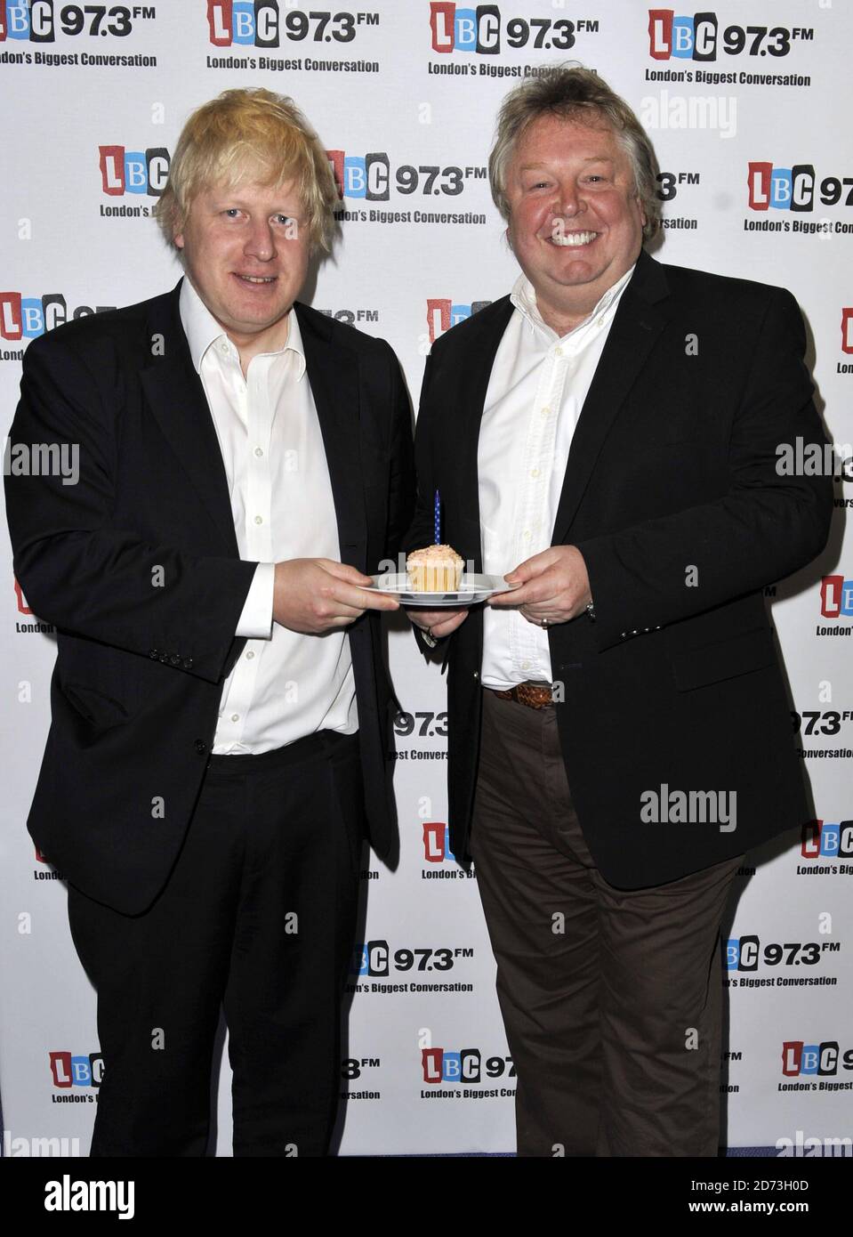 London mayor Boris Johnson (left) is presented with a first birthday ...