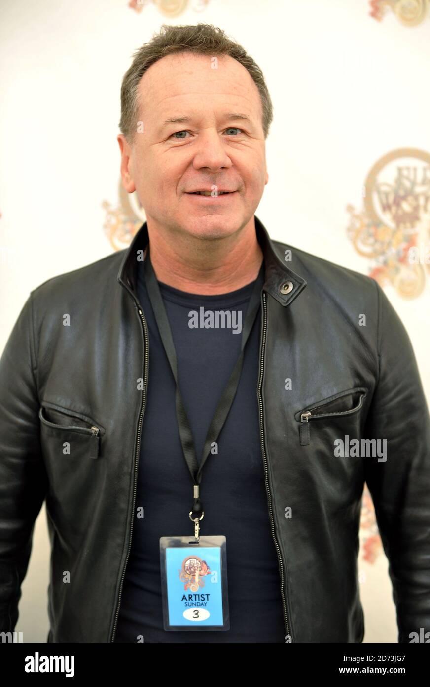 Jim Kerr poses for photographs backstage on the third day of the Isle ...