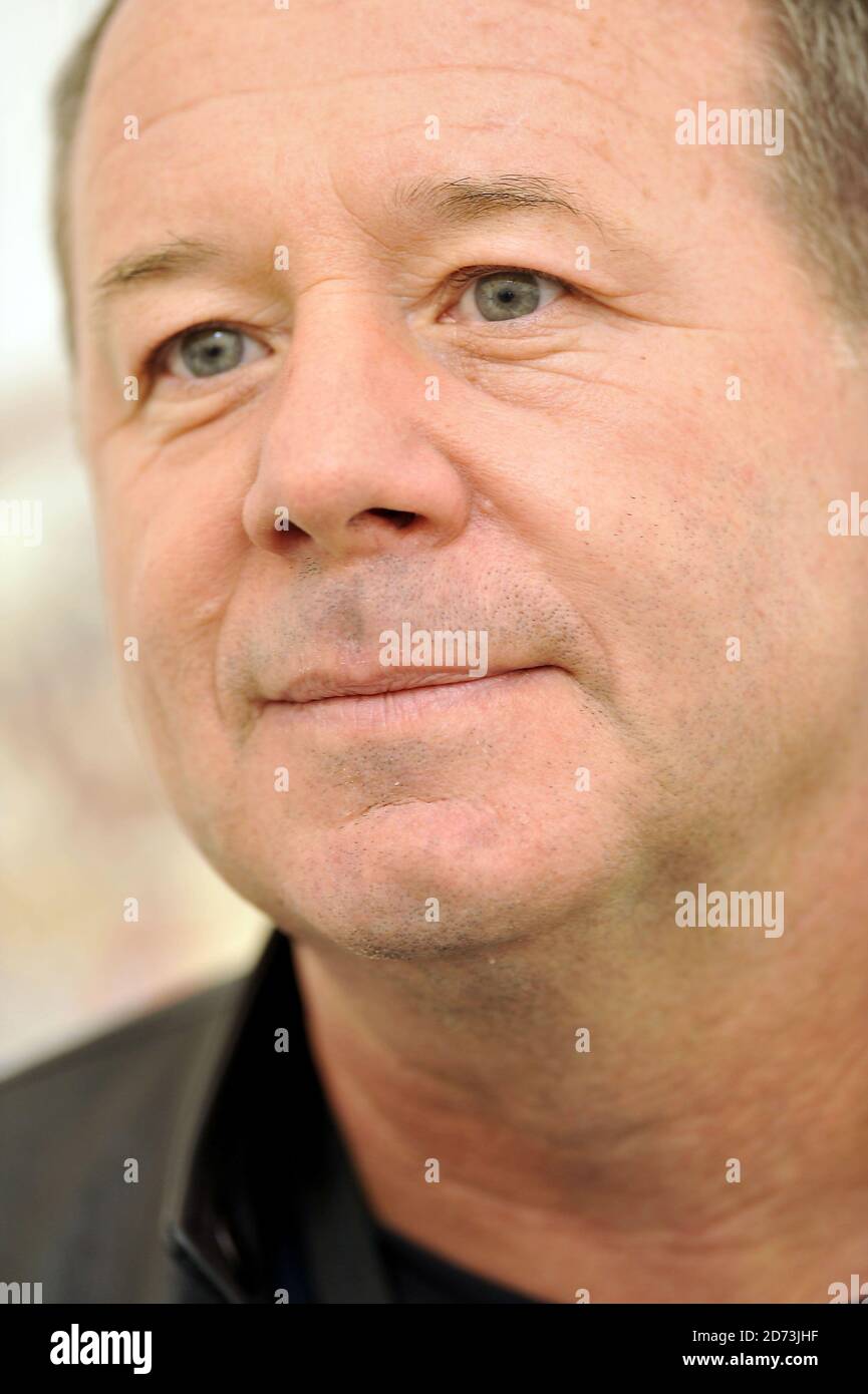 Jim Kerr poses for photographs backstage on the third day of the Isle ...