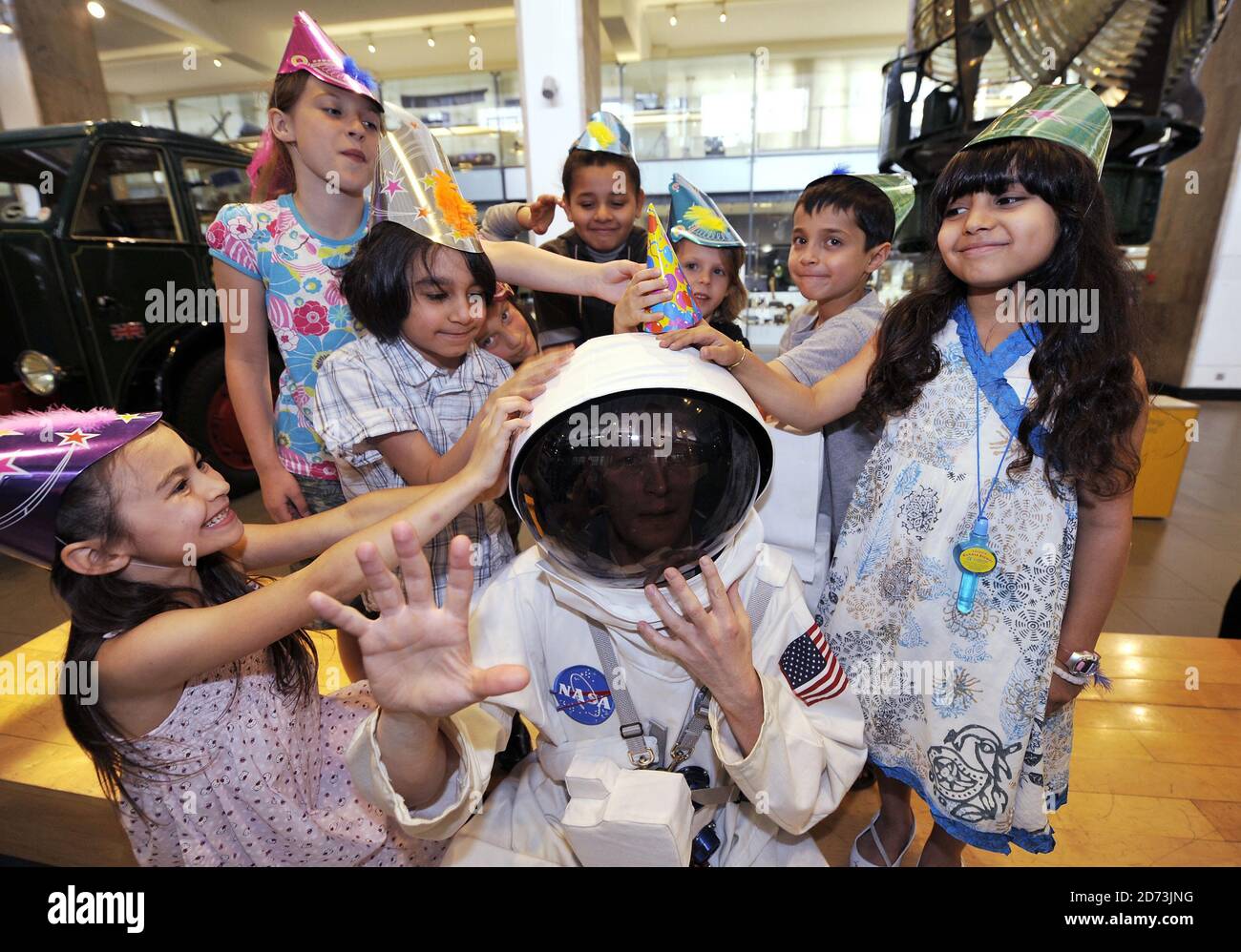 Children play with a robot during a Centenary celebrations event at the ...
