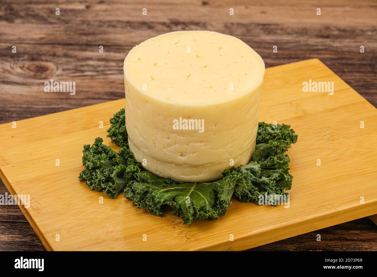 Yellow round dairy soft cheese piece Stock Photo - Alamy
