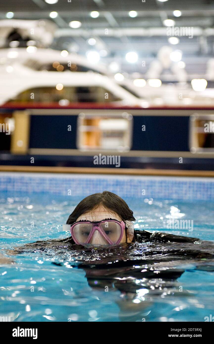 Charlotte, aged 10, demonstrates diving equipment at the Andark stand ...