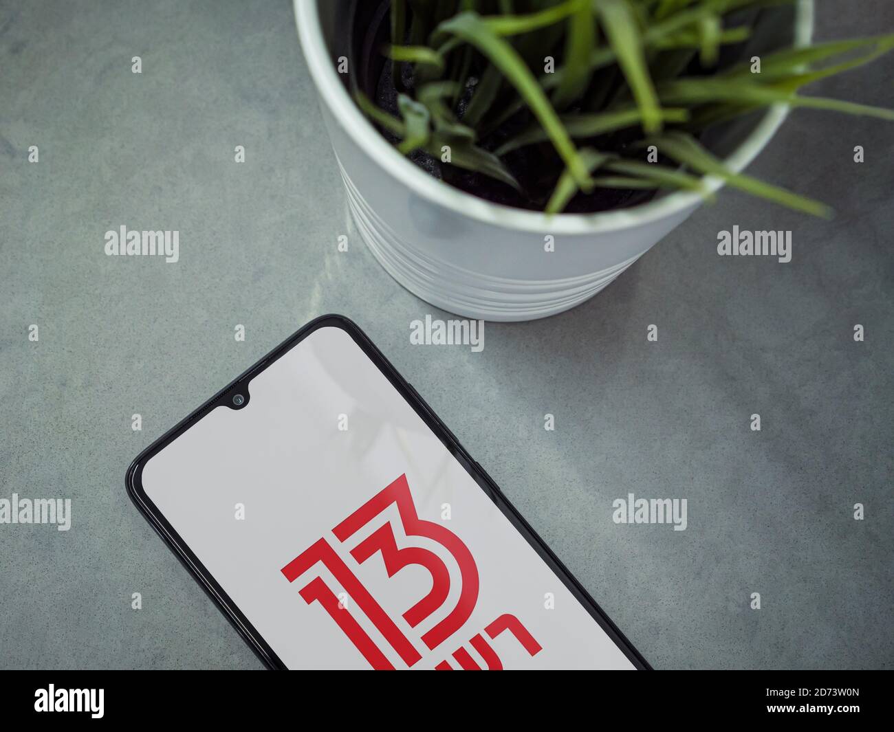 Lod, Israel - July 8, 2020: Modern minimalist office workspace with black mobile smartphone with ...