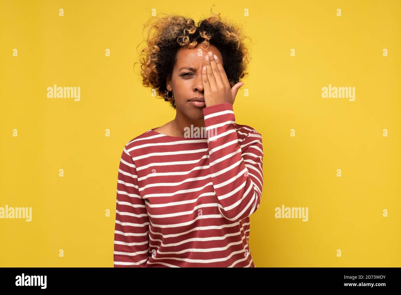 African yougn woman with curlyy hair covering one eye on eyesight ...