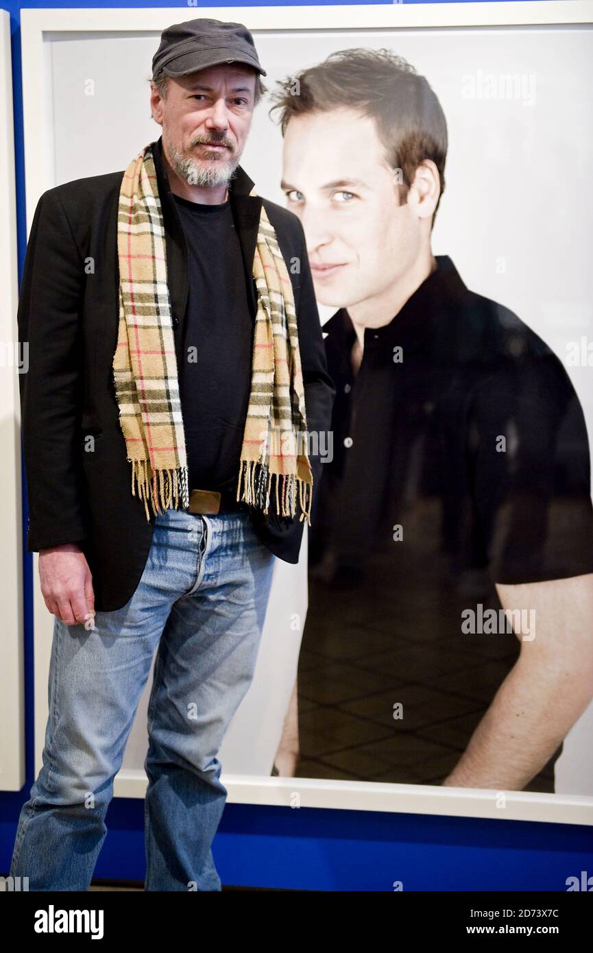 Photographer Jeff Hubbard poses in front of his photographs at the ...