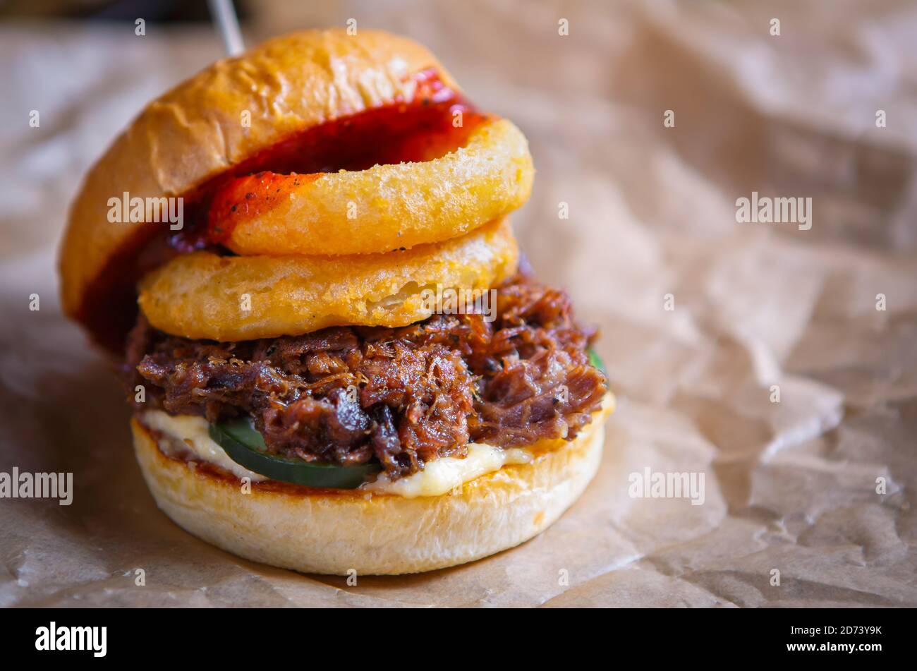 Big tasty exotic burger with fried onion rings, rosted beef meat ...