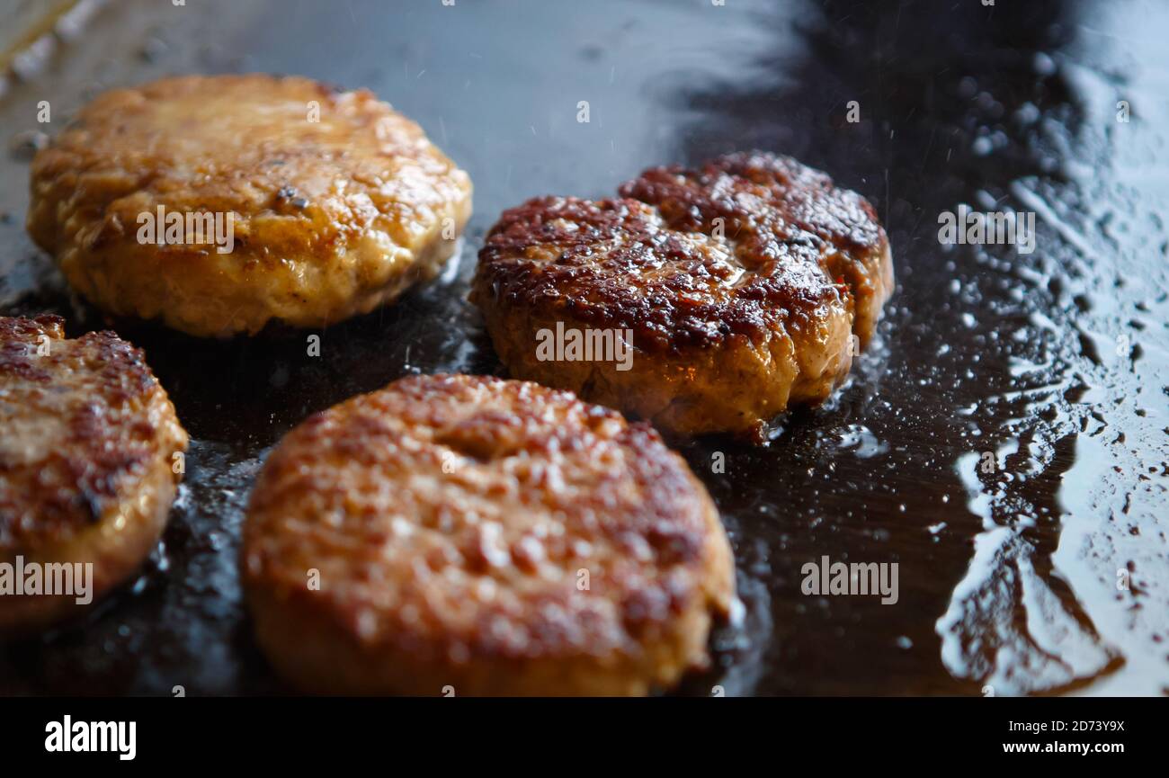 Beef meat patty frying on hot pan in fast food restaurant kitchen for ...