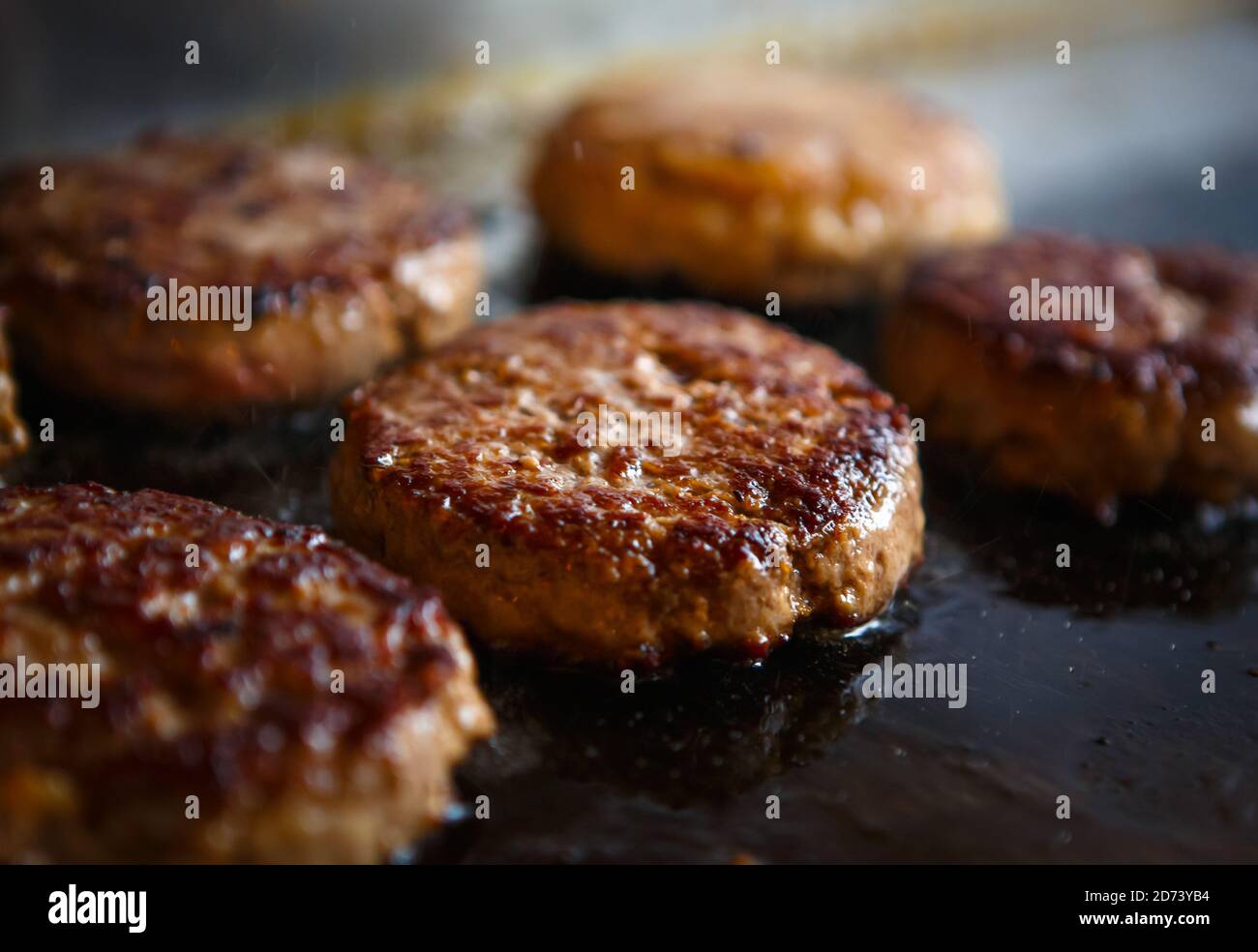 Beef meat patty frying on hot pan in fast food restaurant kitchen for ...