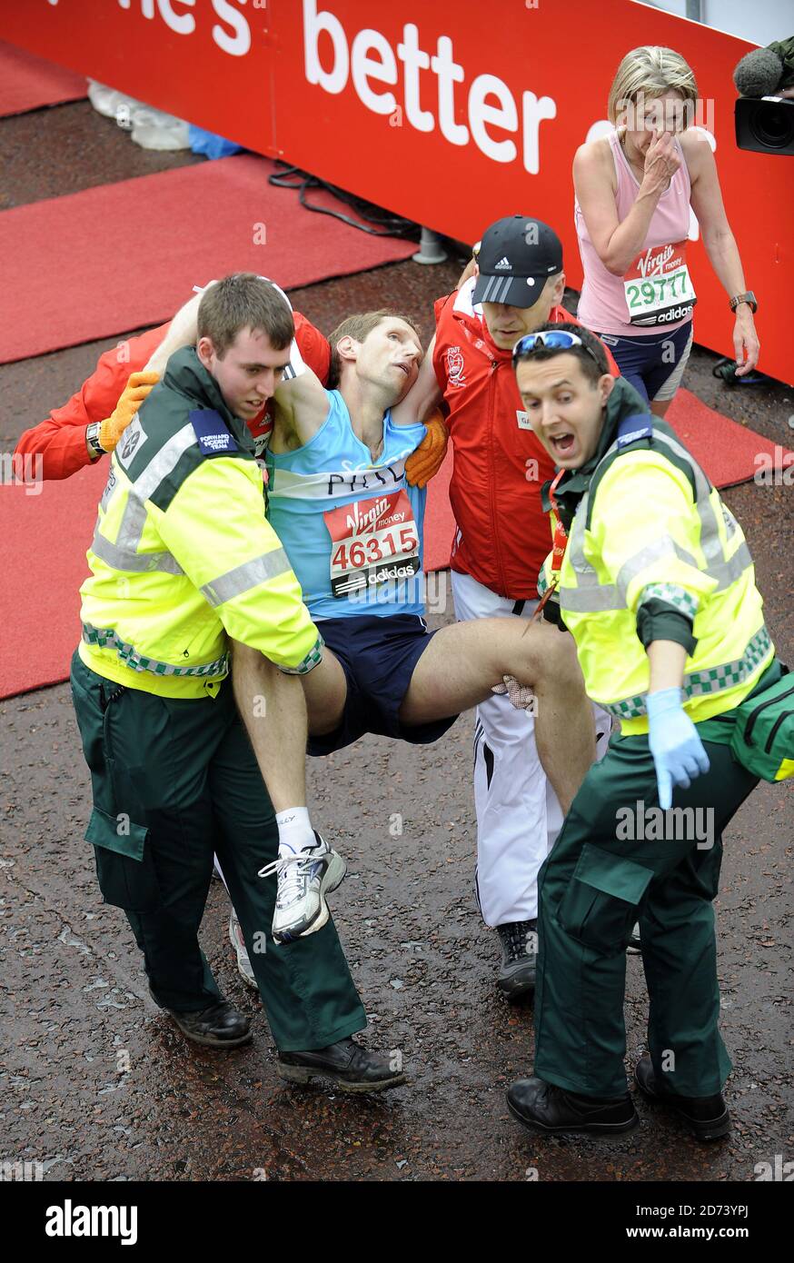 Runners struggle as they finish the 2010 London Marathon, on the Mall ...