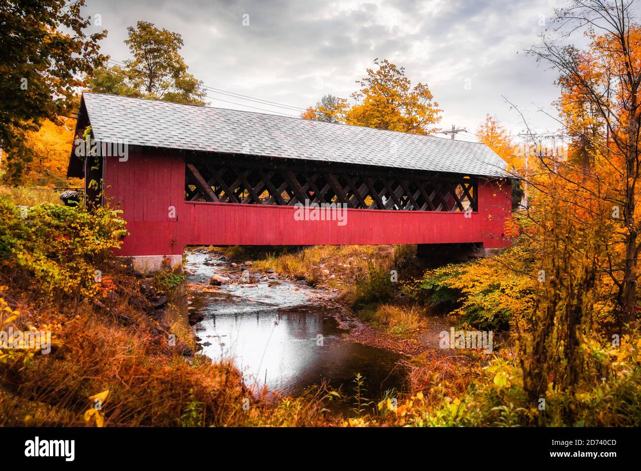 Beautiful Vermont covered bridge surrounded by colorful fall foliage ...