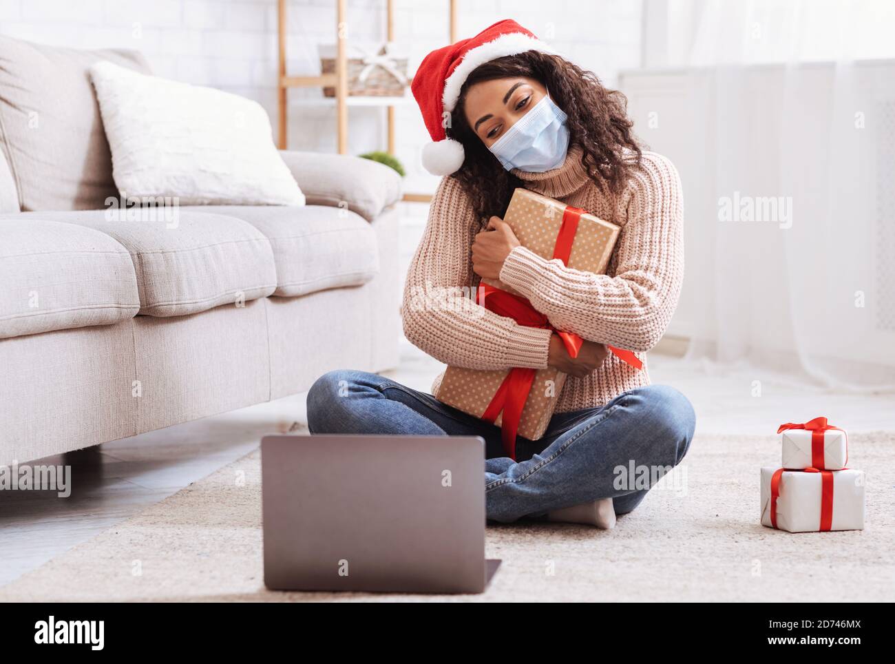 African American Woman Hugging Present Box Wearing Mask Stock Photo - Alamy
