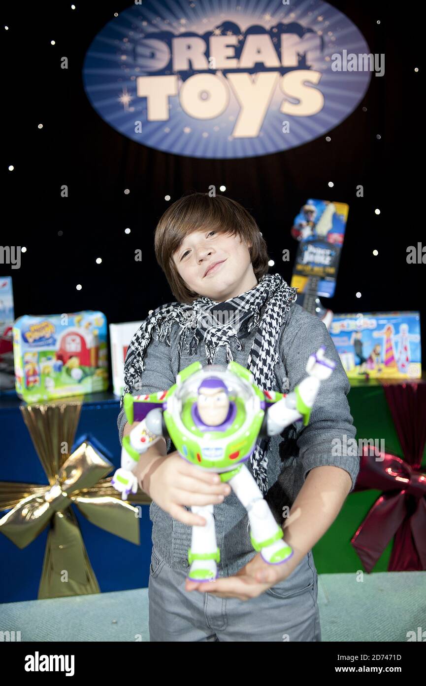 A boy plays with a Buzz Lightyear toy at the Dream Toys exhibition in ...