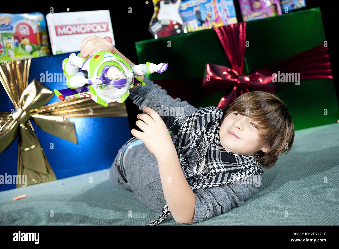 A boy plays with a Buzz Lightyear toy at the Dream Toys exhibition in ...