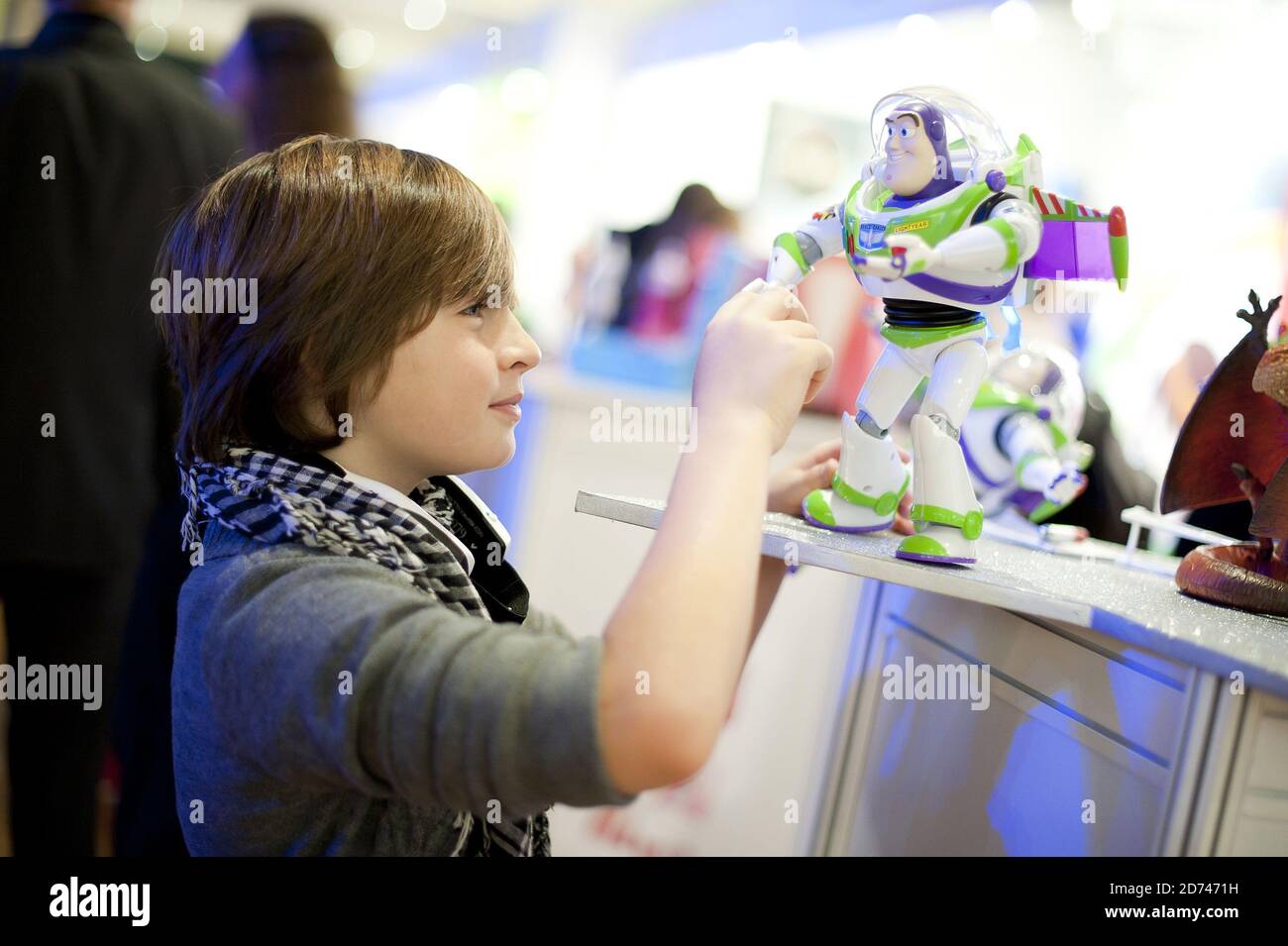 A boy plays with a Buzz Lightyear toy at the Dream Toys exhibition in ...