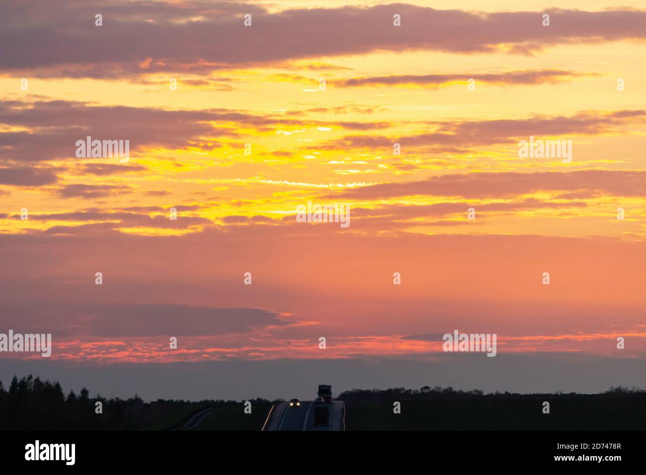 sunset over a two-lane road Stock Photo - Alamy