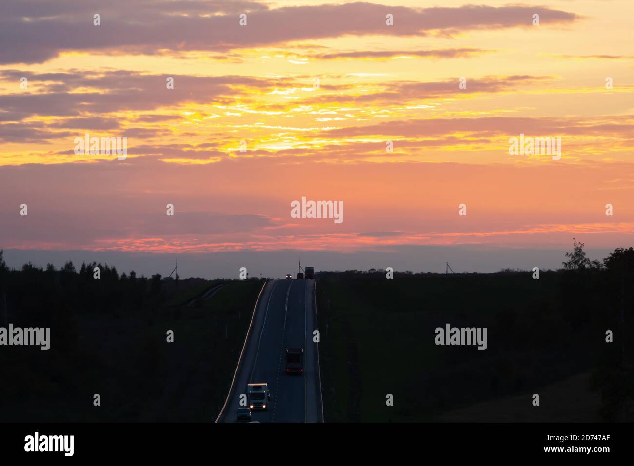 sunset over a two-lane road Stock Photo - Alamy