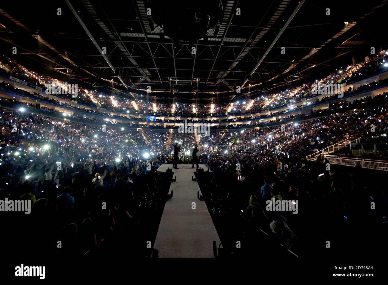 The crowd stage a 'mexican wave' with their mobile phones at the ...