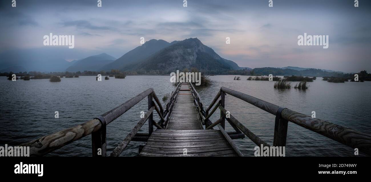 a wood bridge on a lake Stock Photo - Alamy