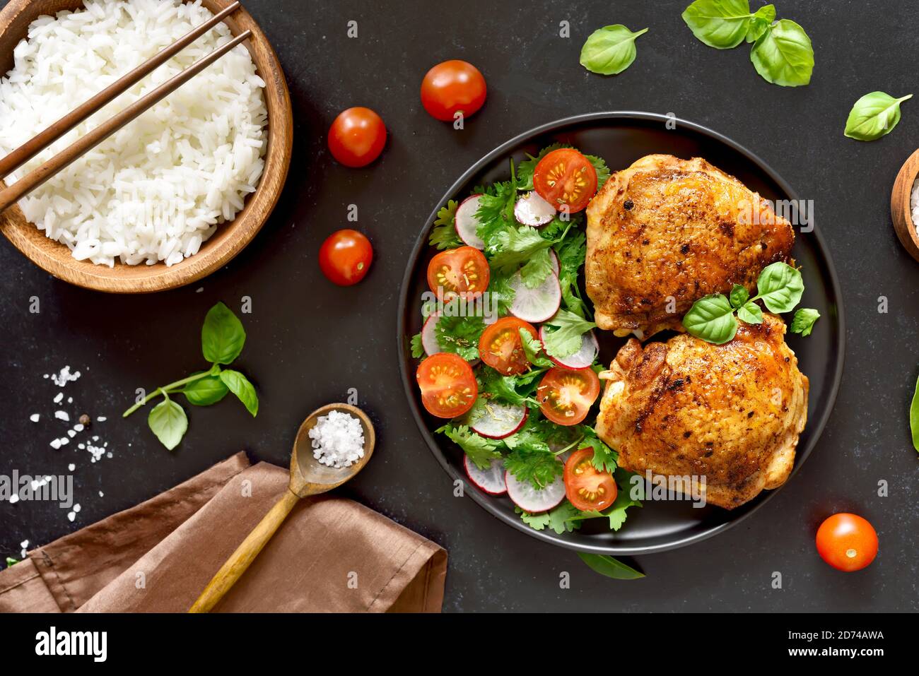 Fried chicken thighs with vegetables in plate and bowl of rice over ...
