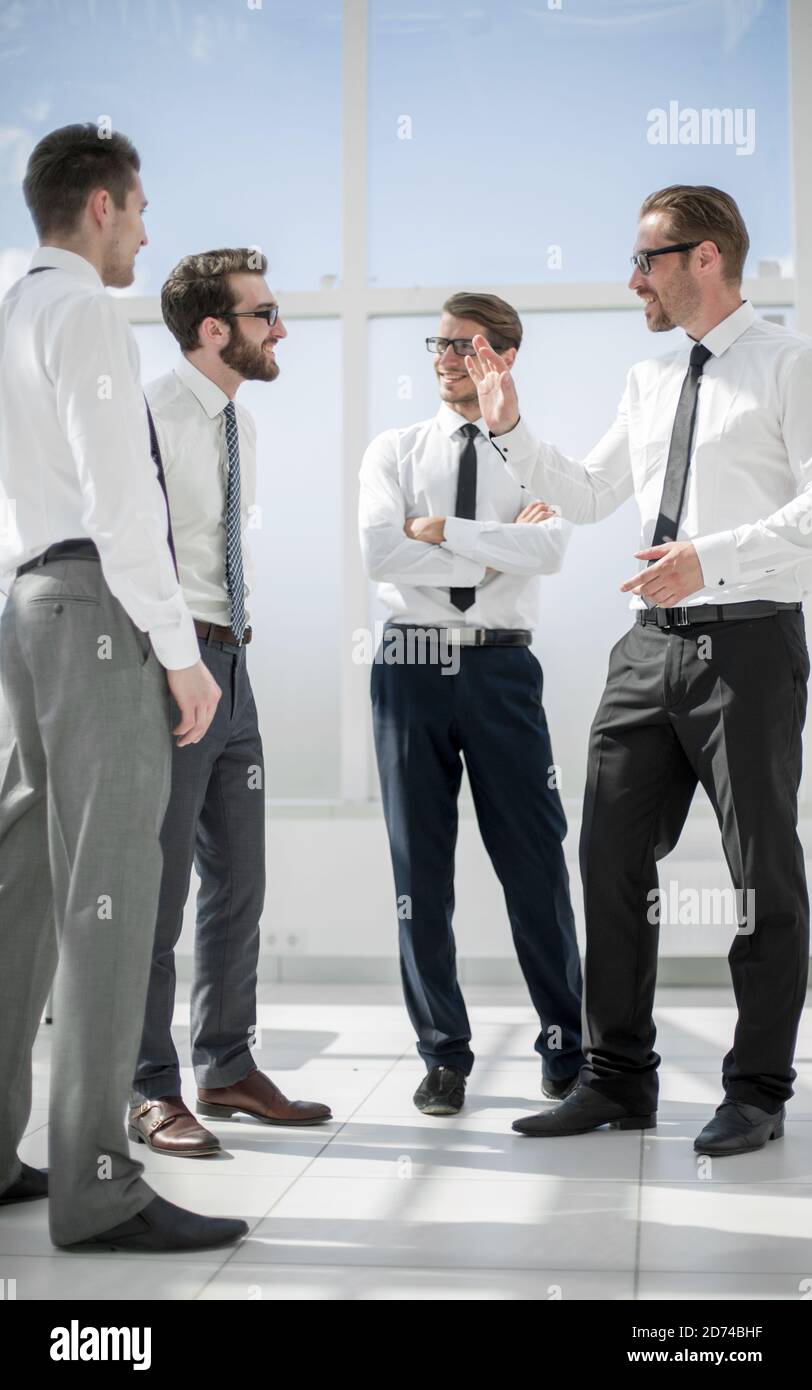 employees discussing their ideas standing in the office lobby Stock ...