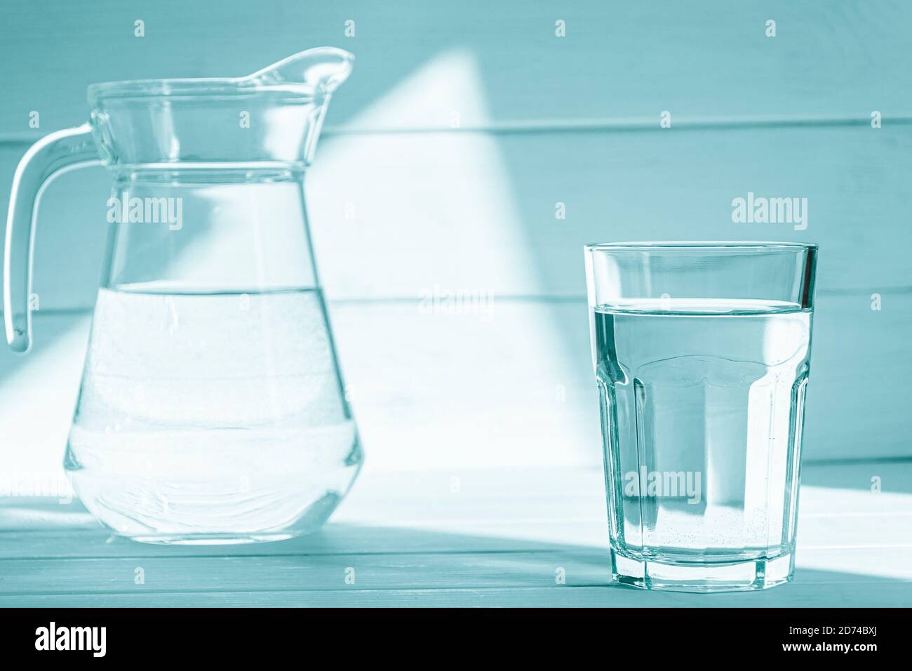 Pure clear water in the glass stands on a wooden background. Healthy ...