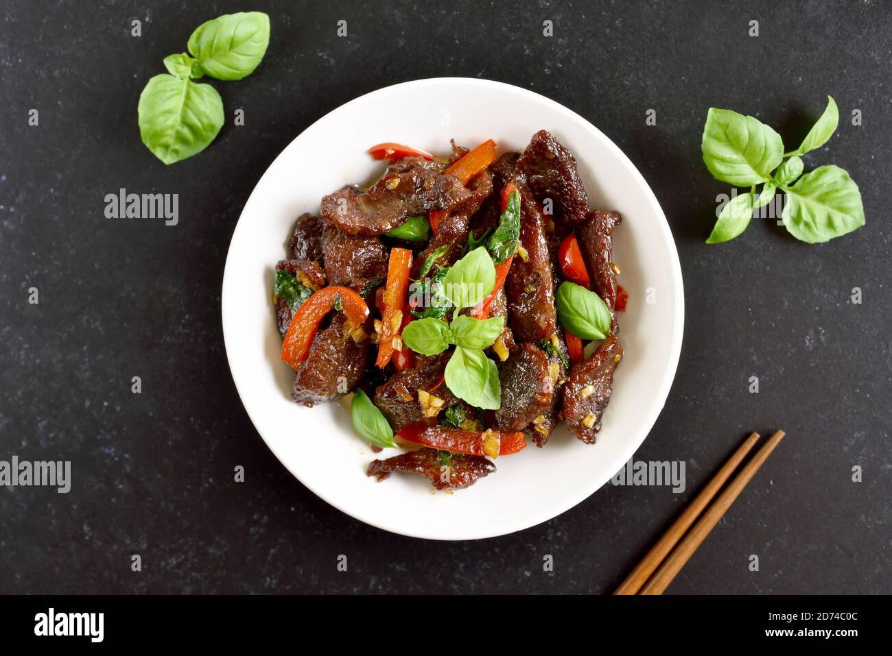 Thai style stir-fry beef with vegetables in bowl. Top view, flat lay ...